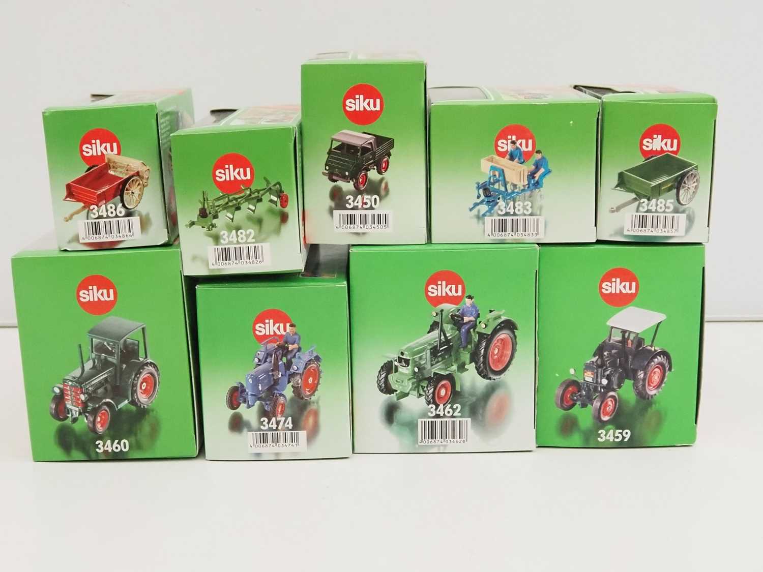 Lot 85 - A group of SIKU 1:32 scale diecast tractors,